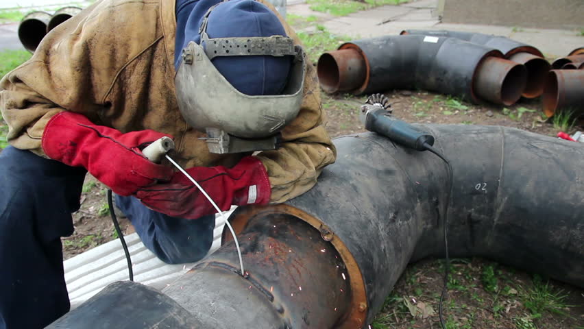Welder Welding On A Large Pipe. Metalwork. Man Welder Welding Outdoors ...