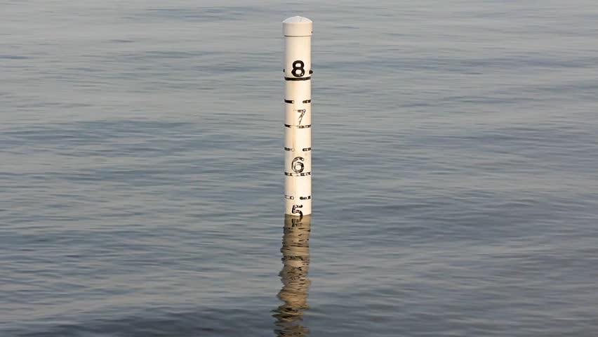 Row Of Buoy Markers And A Depth Indicator From The Shore Of A Lake ...